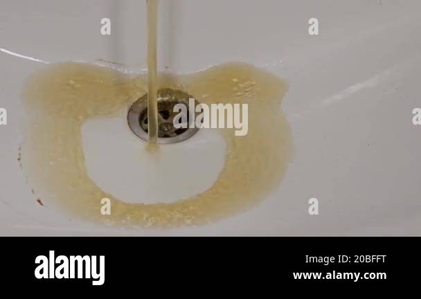 Dirty water flows from the tap into the sink. Contamination of drinking ...