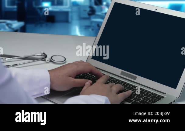 Close up of smart doctor working and looking at laptop with human ...