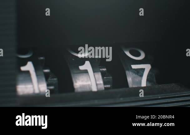 Close-up view of a vintage mechanical counter with numbers rolling ...