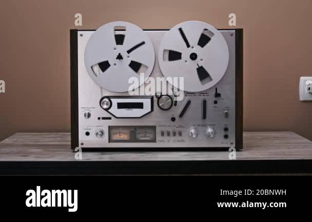 A centered front-facing view of a vintage reel-to-reel tape recorder ...
