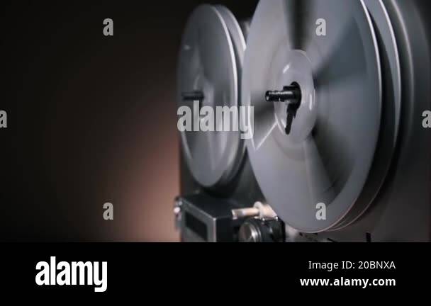 A reel-to-reel machines spools rotate, filled with magnetic tape ...