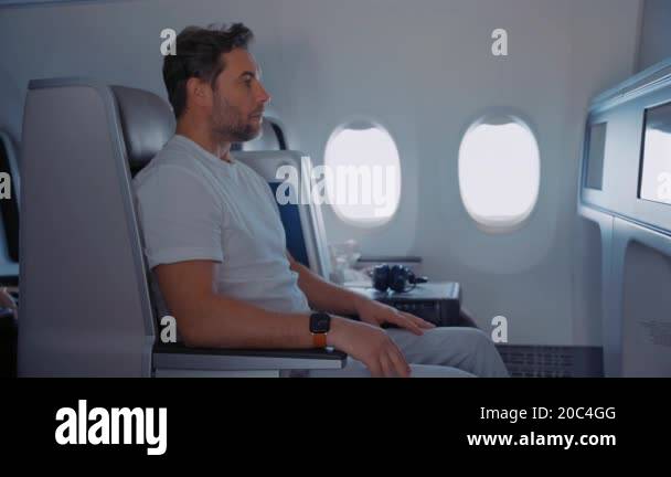 Scared Male Passenger Looking Out The Window Airplane. Man having a ...