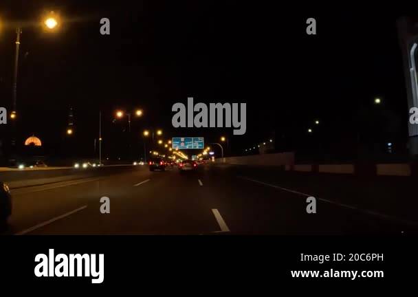 Cars navigating through a darkened road smooth drive with warm street ...