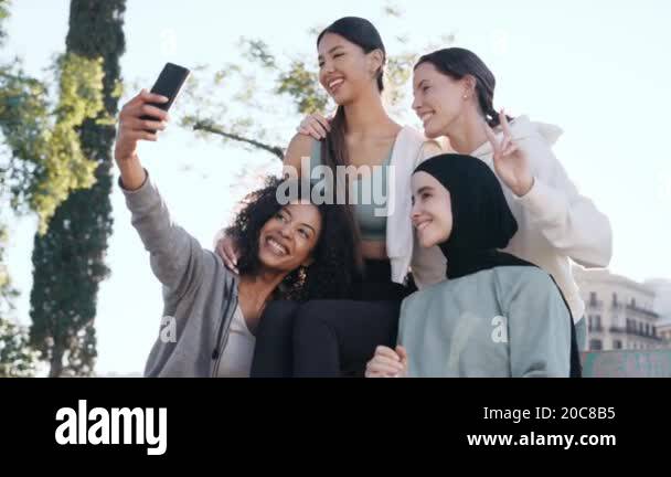 Video of a group of pretty friends with sporty clothes taking a selfie ...