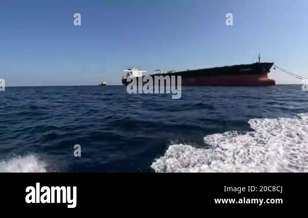 A stunning view of a bulk carrier cruising through the sparkling waters ...