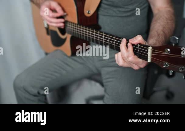 Musician hands pressing guitar strings, producing melodic sound during ...