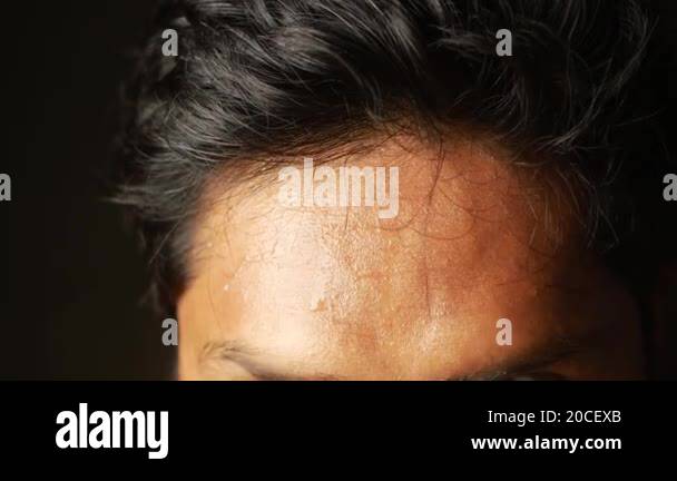 closeup of sweat on forehead against dark background Stock Video ...