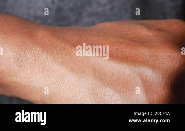 Closeup of a human hand highlighting prominent veins and intricate skin ...