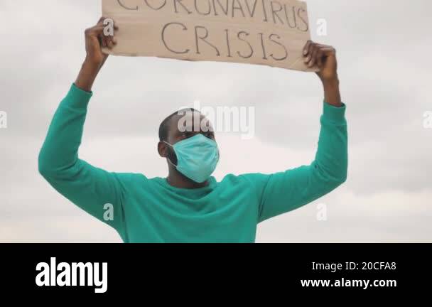 Portrait persistent young black man wearing face mask and striking with ...