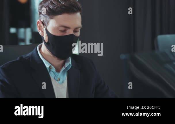 Close up man wear mask work use computer in modern office business ...