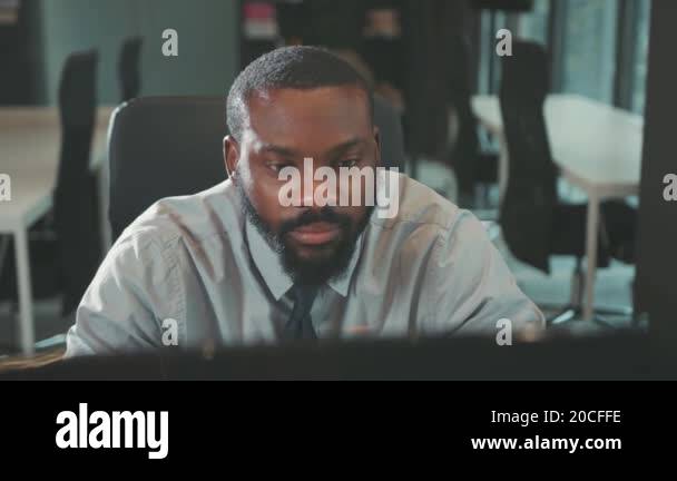 Handsome face African American handsome man uses computer for work in ...