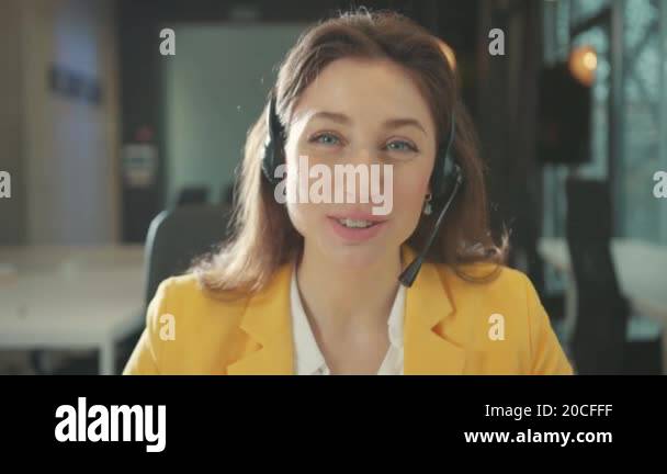 Beautiful smart young caucasian woman wear headset consulting by online conference video chat ...