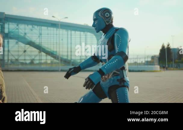 A little girl greets her robot friend hugging it future machine ...