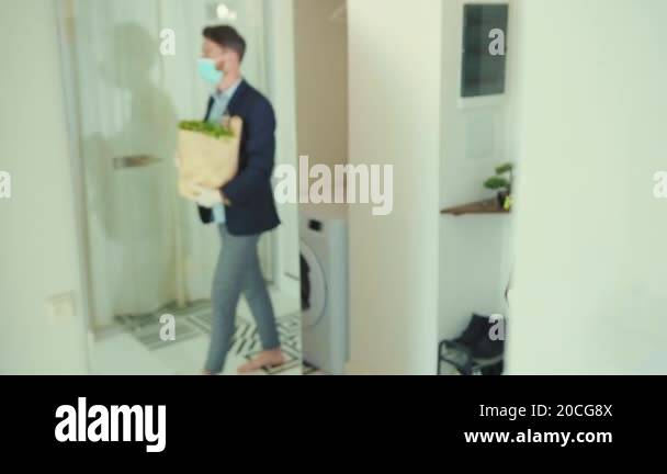 Close up stylish man coming back home after food shopping entering ...