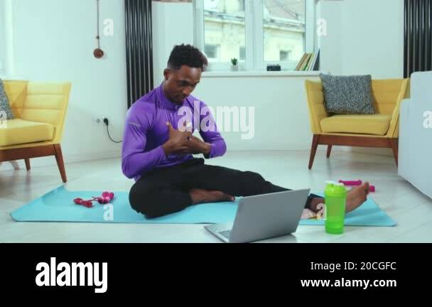 Trainer African american man online training talking and using laptop equipment remote ...