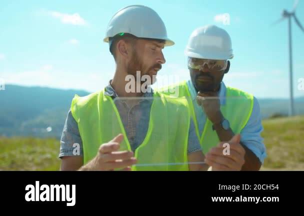 Face men engineers hold glass futuistic gadget tablet computer hologram ...