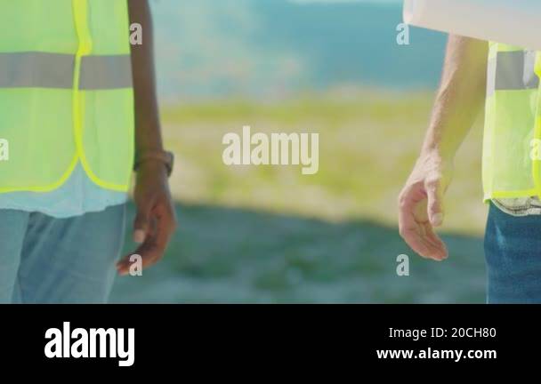 Close up young engineer men or workers shake hands people work industry ...