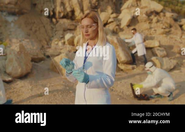 Woman ecology expert use transparent screen tablet computer in ...