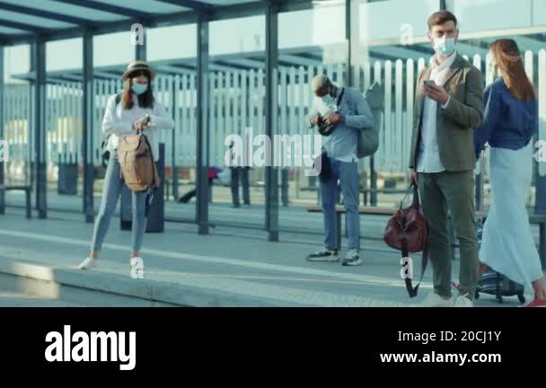Close up mixed-races young people in medical masks standing waiting for ...