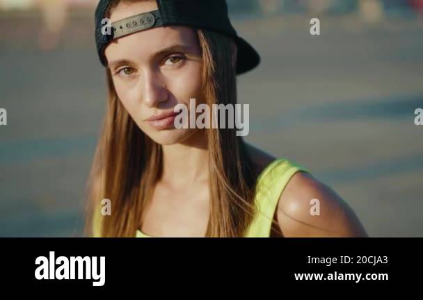 Close up stylish woman with cap look at camera smiling standing on ...