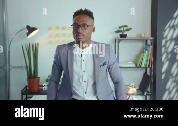 African american cheerful male boss with beard looking to camera in ...