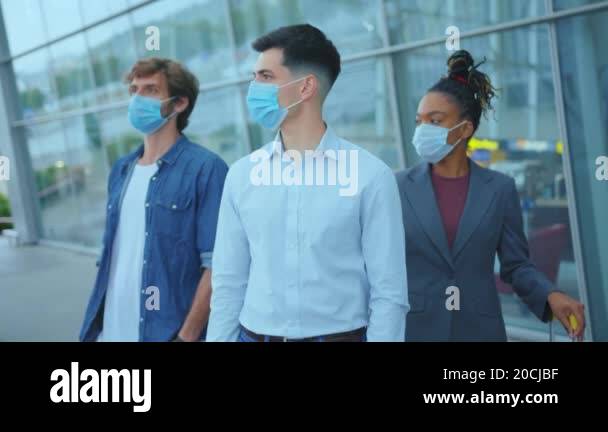 Group of three successful people with face masks standing together ...