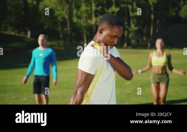 African american fitness coach handsome man stretching with resistance ...