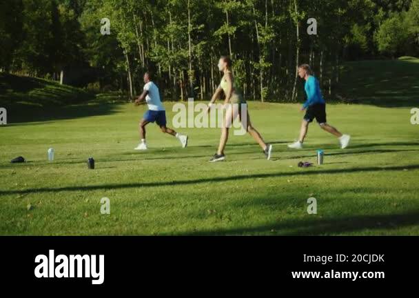 Outdoor fitness session. Cardio workout. Three fit fitness young people ...