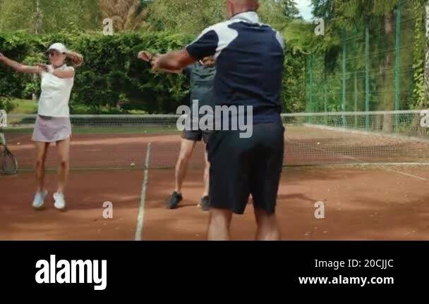 Players warm up before a game of tennis with trainer success match ...