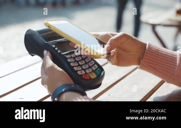Customer paying for order in the cafe with payment terminal using NFC ...