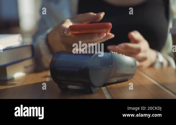 Customer paying for order in the cafe with payment terminal using NFC ...