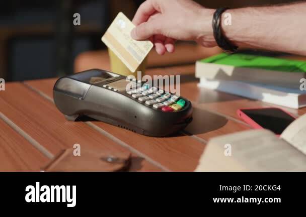 Young hands man payment with credit card in cafe customer hold phone ...