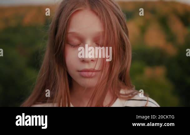 Portrait teenager girl in windy forest open eyes looking at camera ...