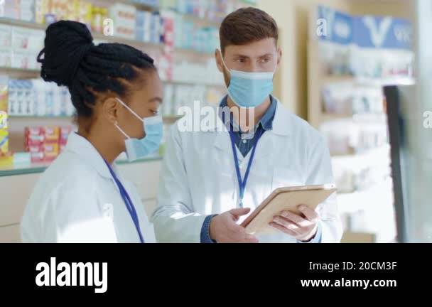 African american female doctor with intern pharmacist learning ...