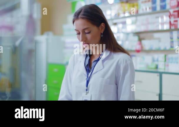 Pharmacy expert young woman learning medication details with computer ...