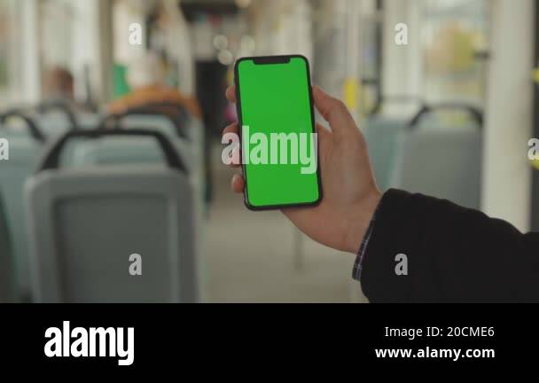 NEW YORK - May 19, 2019: Young man young hand uses holding a mobile telephone with a vertical ...