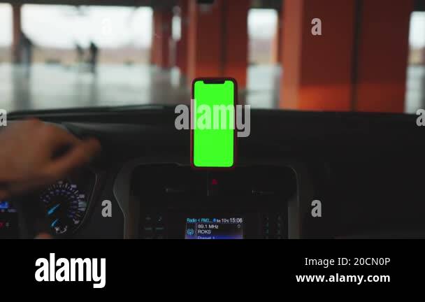 NEW YORK - April 5, 2019: Close up hands man drive car smartphone with ...