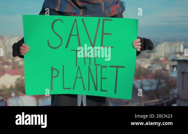 Hands man activist with Save the Planet ecology poster view of city ...