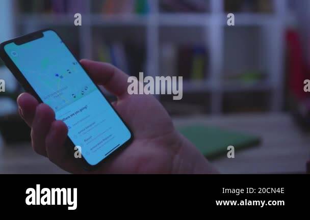 NEW YORK - May 19, 2019: Young hands man uses a phone touch scrolling ...