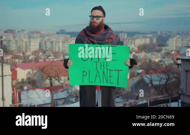 Serious bearded man activist with Save the Planet ecology poster view ...