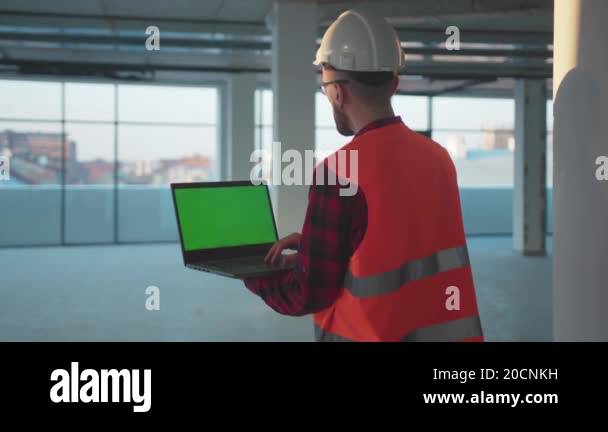 Man stand look around engineer using laptop computer with green screen ...