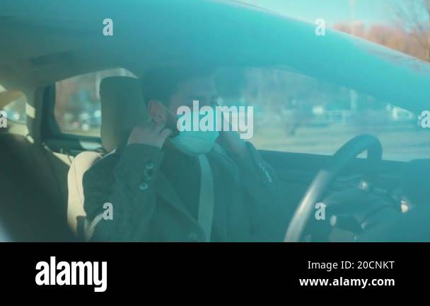 Close up man gets in the car coughs removes Protective Face Mask COVID ...