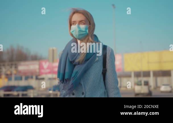 Close up medical worker in a protective suit screening passenger to ...