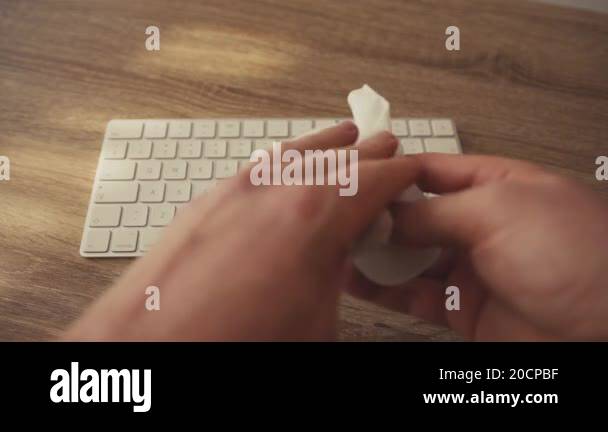Pov cleaning computer mouth and keyboard at working desk. Close-up male ...