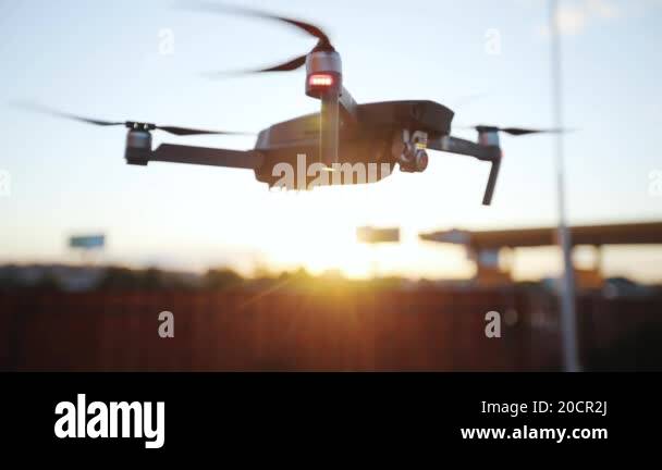 Quadcopter flying in the beautiful sunset machine contemporary business ...