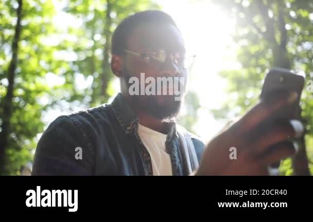 Close up face serious african American young attractive man use phone ...