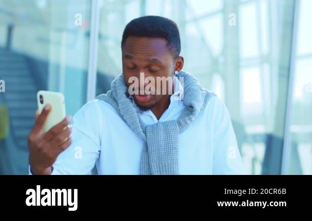 Nervous African American man use smartphone for video call speaking ...