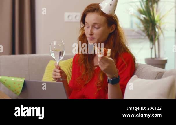 Attractive ginger birthday girl celebrating holiday alone talking with distant friend sharing ...