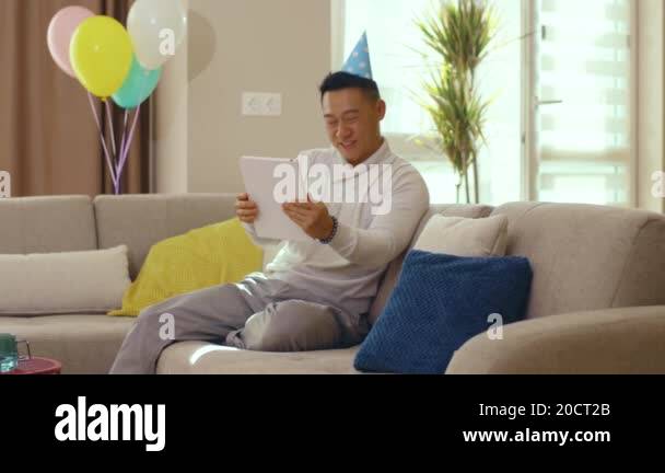 Chinese handsome guy celebrating holiday event wearing birthday hat ...