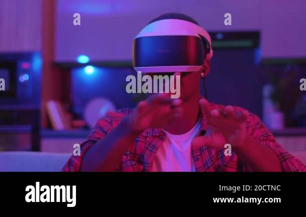At home gaming person young man wearing VR glasses entertaining ...